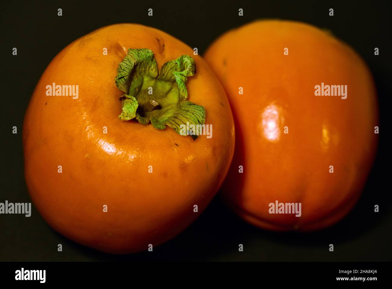 Two ripe persimmons for a healthy meal Stock Photo - Alamy