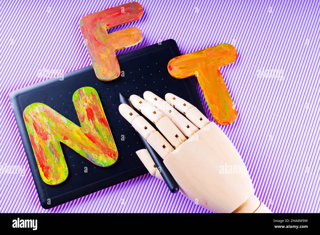 NFT (Non-Fungible token). Artificial hand creates crypto art using a ...