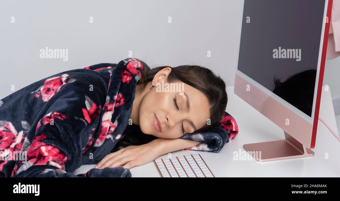 Wiltshire, UK. 2021. Woman working from home asleep by her desktop ...
