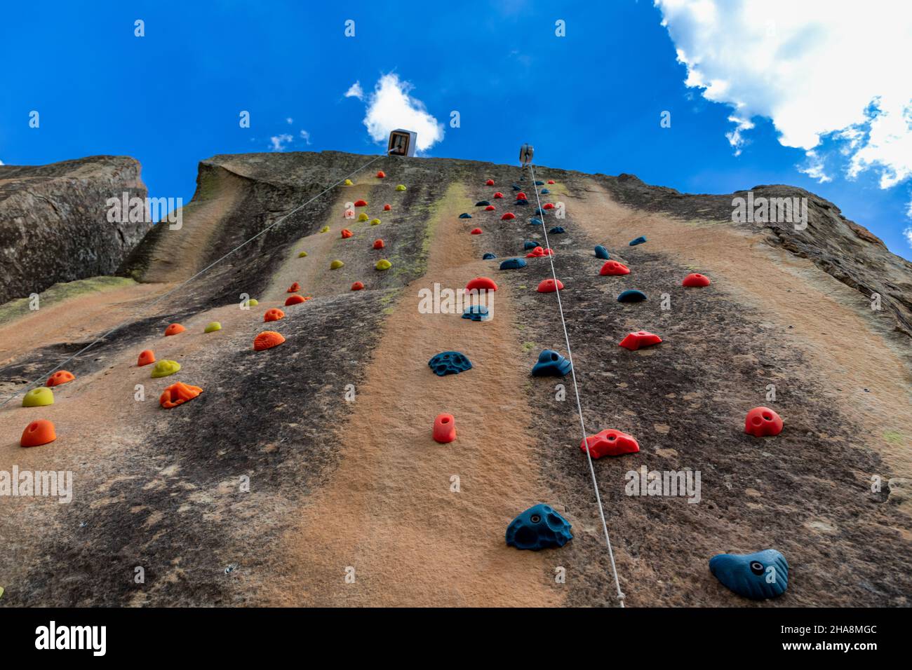 Rock climbing plastic holds in a multi coloured rockface Stock Photo ...