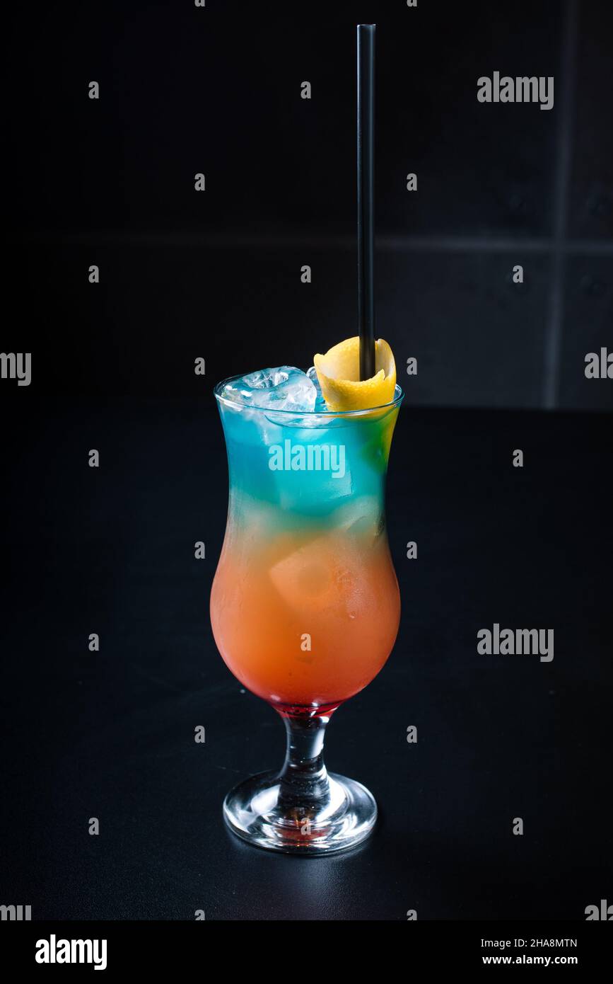 Delicious rainbow citrus cocktail on a dark surface in a bar Stock ...