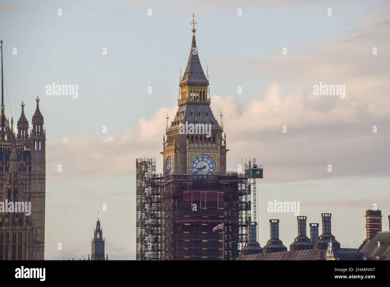 London, UK. 10th December 2021. The top of Big Ben and clock faces are ...