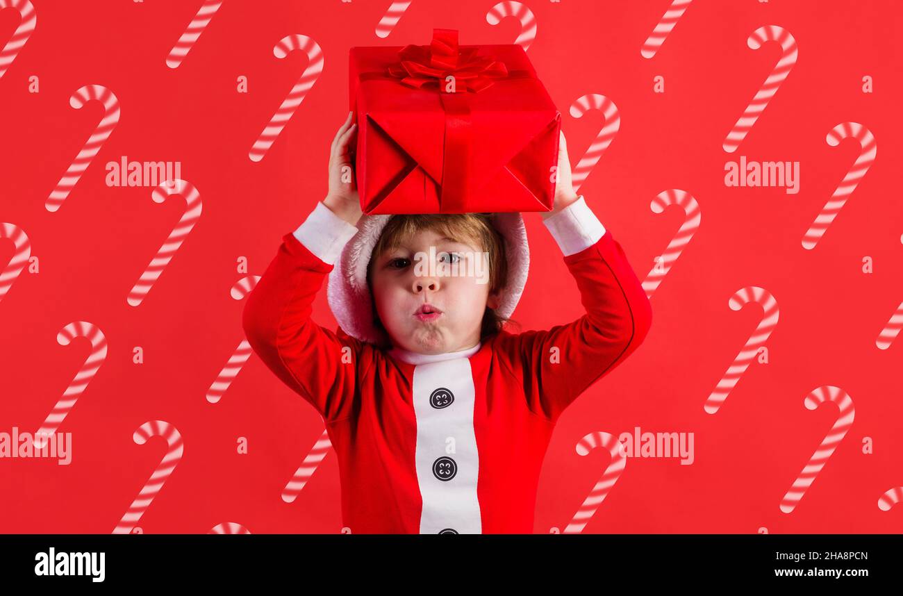 Christmas child with present. Santa helper with gift box. Kid boy in ...