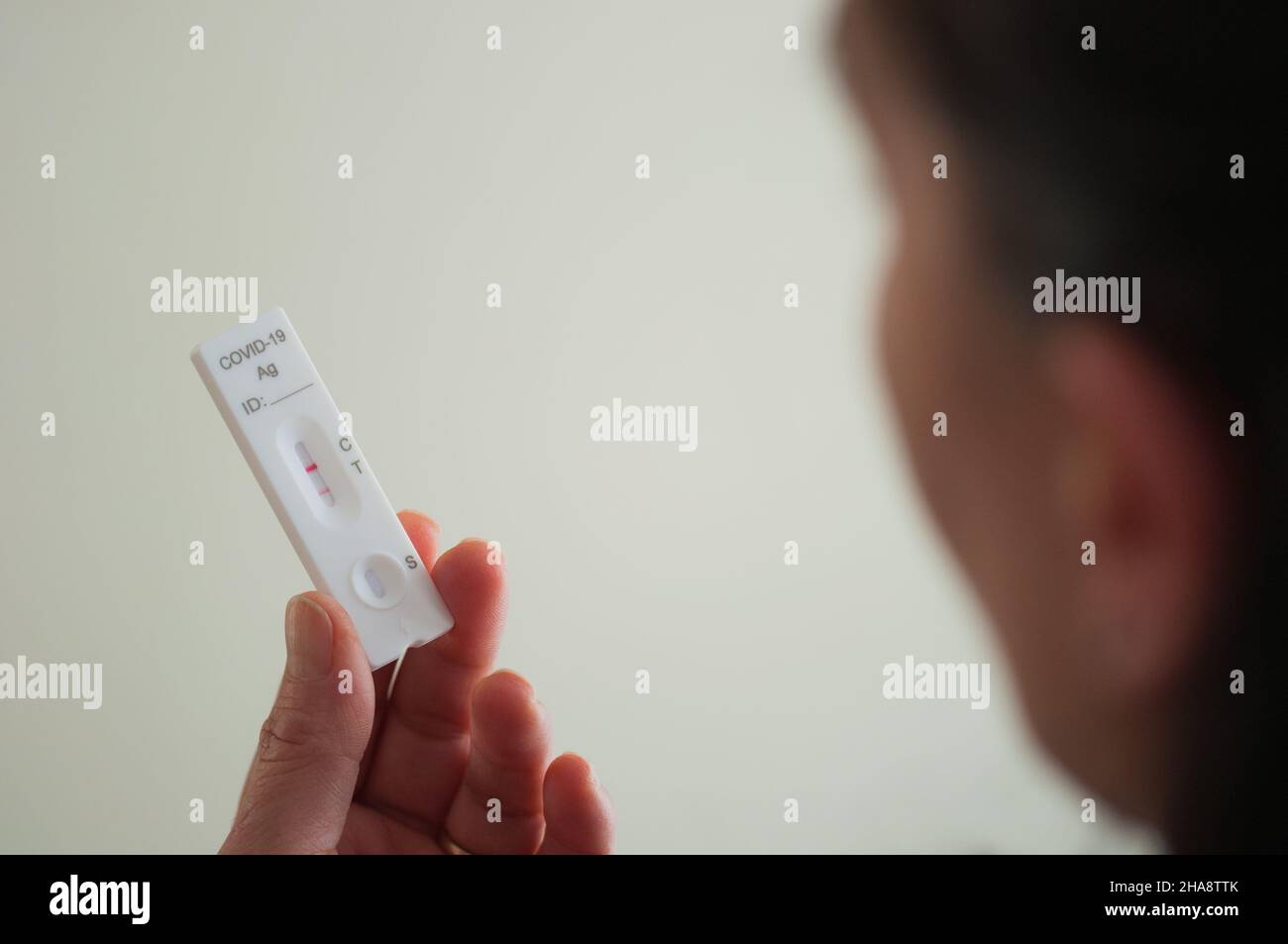 a blurred woman's face shows a positive rapid covid-19 test Stock Photo ...