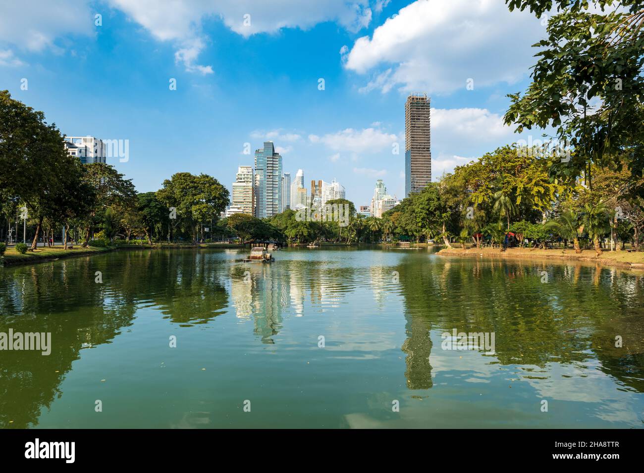 Lumpini park in Bangkok and the skyline of downtown Bangkok central ...