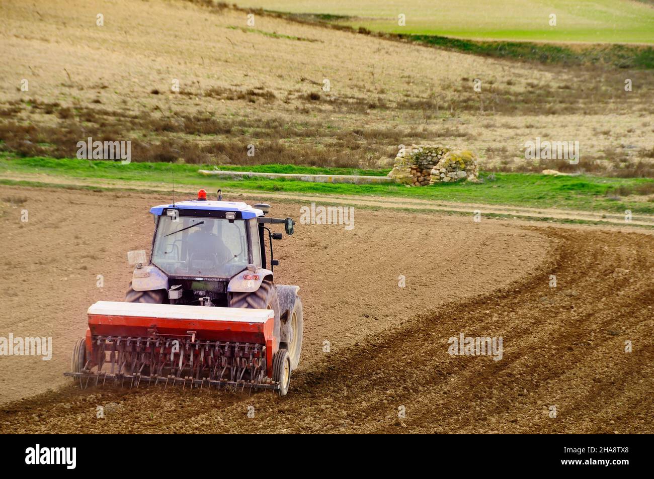 Tractor doing agricultural work in the field Stock Photo - Alamy