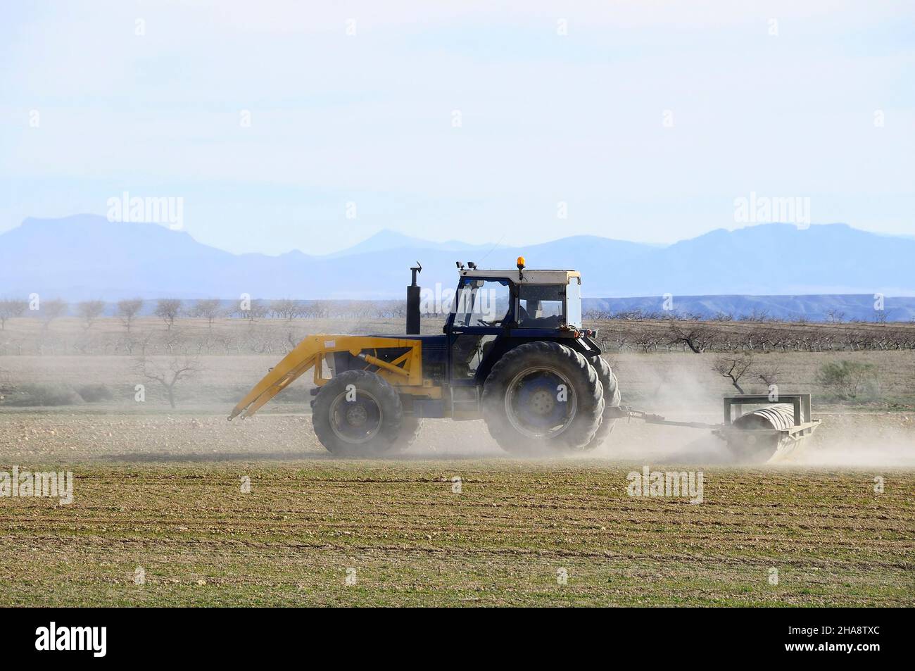 Tractor doing agricultural work in the field Stock Photo - Alamy