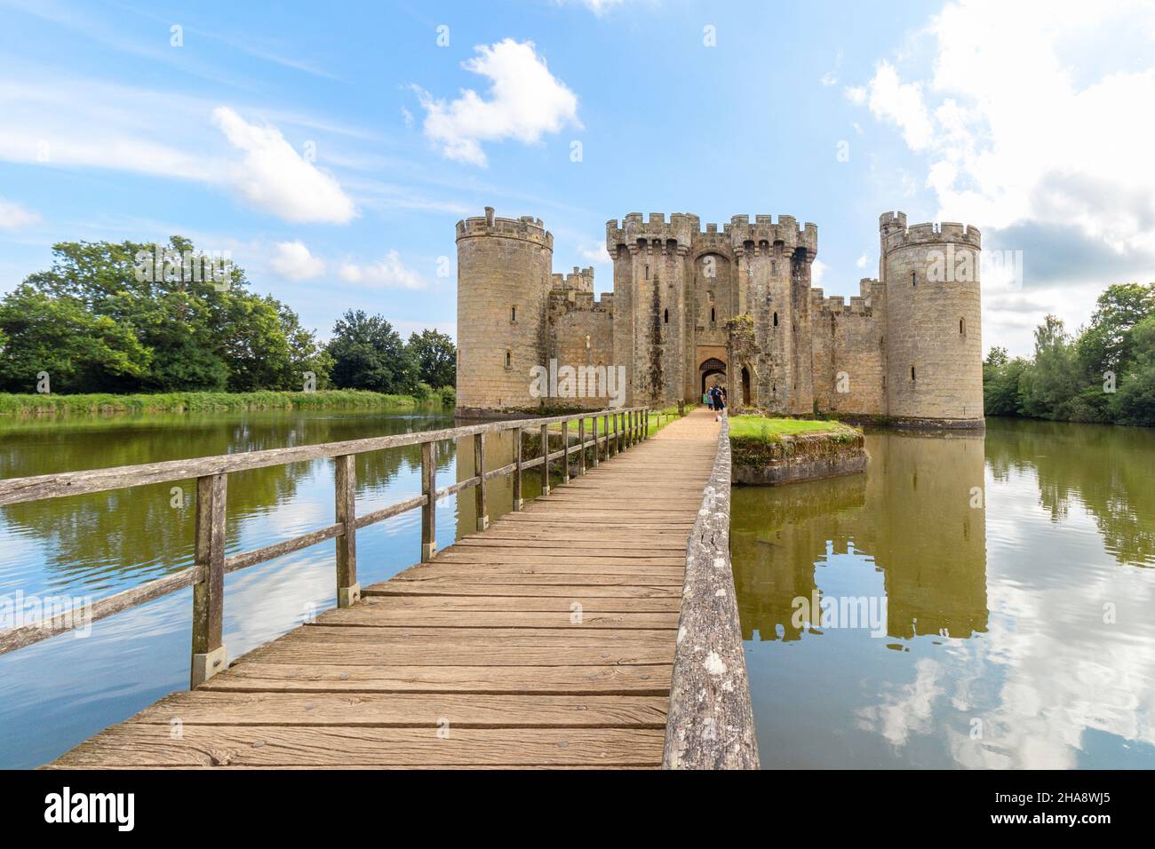 view across wooden bridge to 14th-century moated Bodiam castle near ...