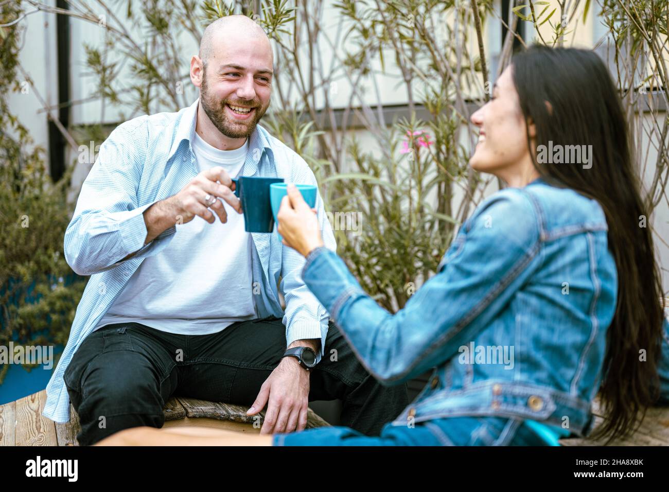 Dating online and meeting, young couple tasting coffee drinks, enjoying ...