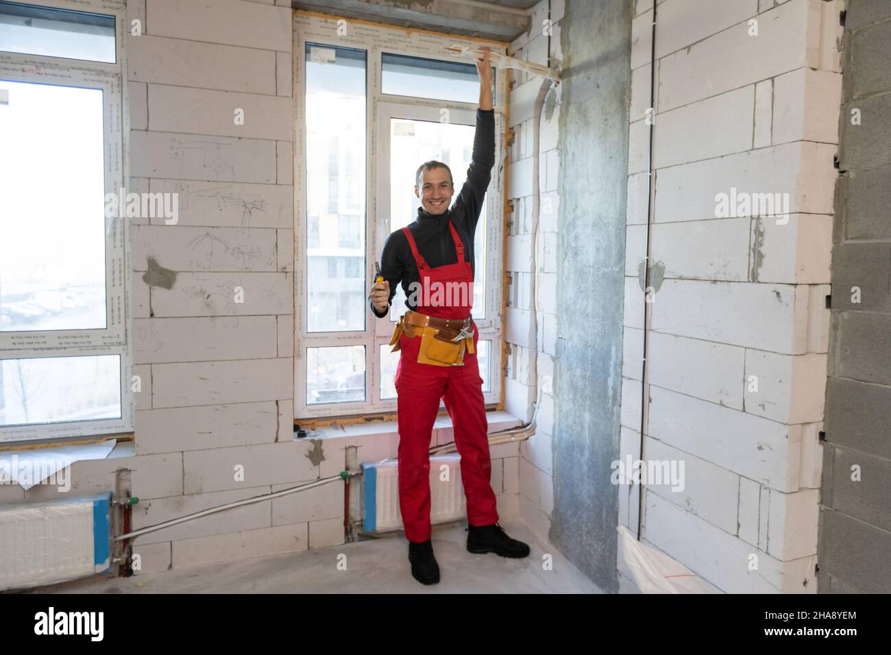 Builder handyman with construction tools. House renovation background ...