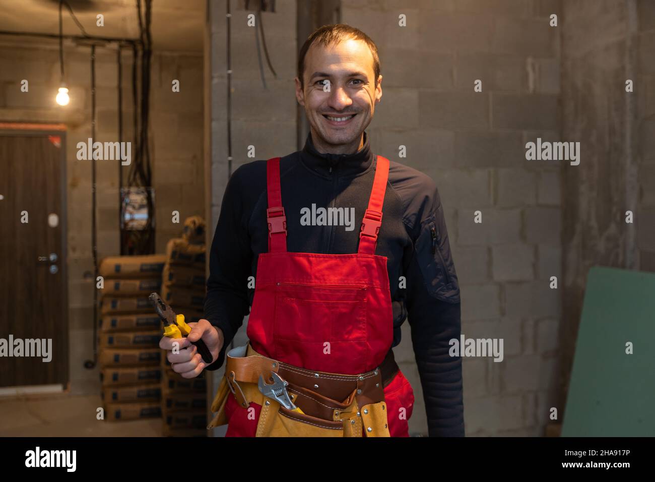 Portrait of cheerful young worker posing looking at camera and smiling ...