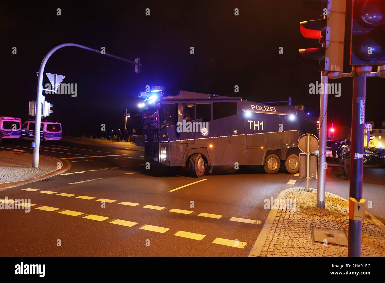 Greiz, Germany. 11th Dec, 2021. A water cannon of the police stands on ...