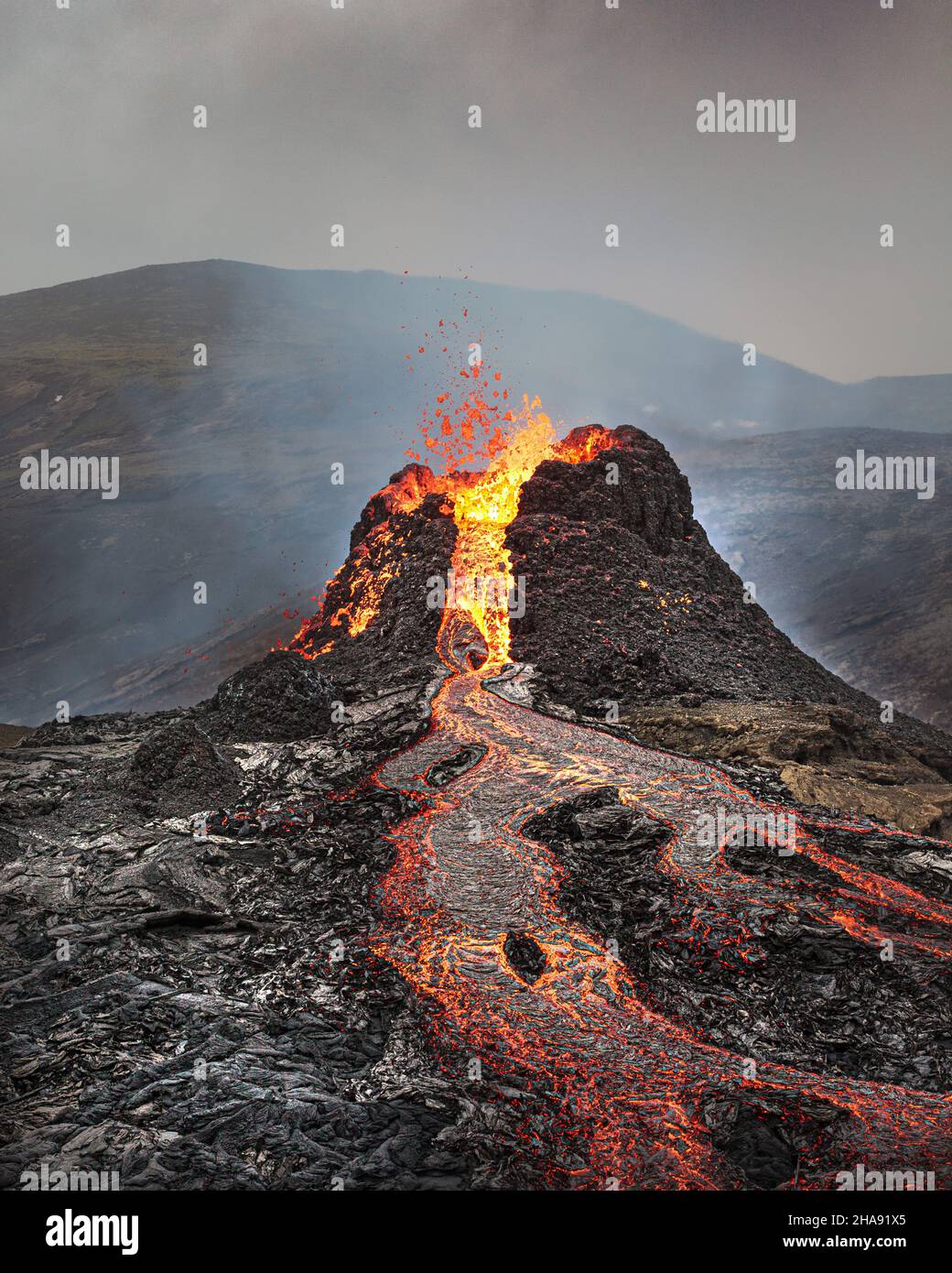 Beautiful shot of an active volcano with flowing lava and smoke under a ...