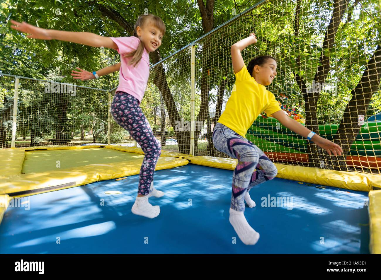 Happy children jumping on trampoline Stock Photo - Alamy