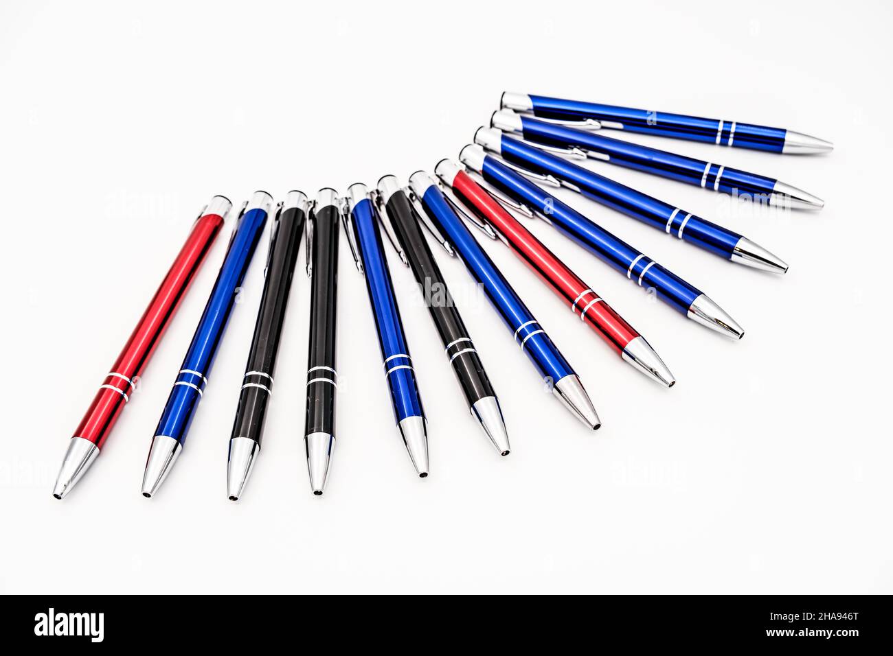 metal pens arranged on white background Stock Photo - Alamy