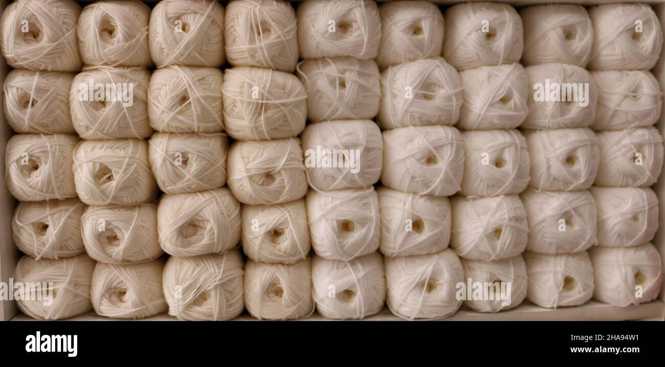 White knitting yarns, yarns lined up on the shelf. Shopping concept and ...