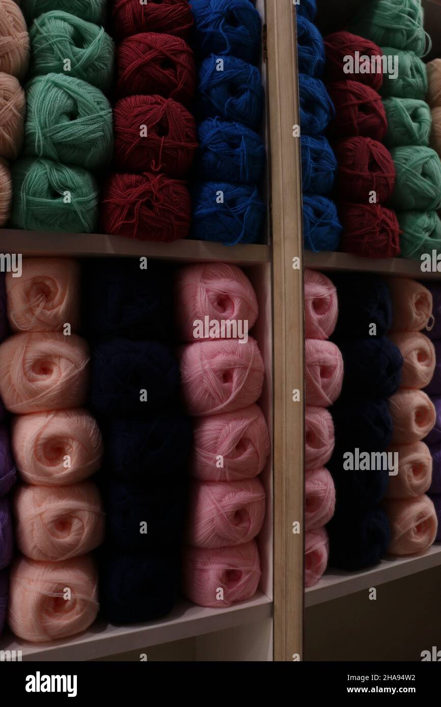 Colorful knitting yarns, yarns lined up on the shelf. Shopping concept ...