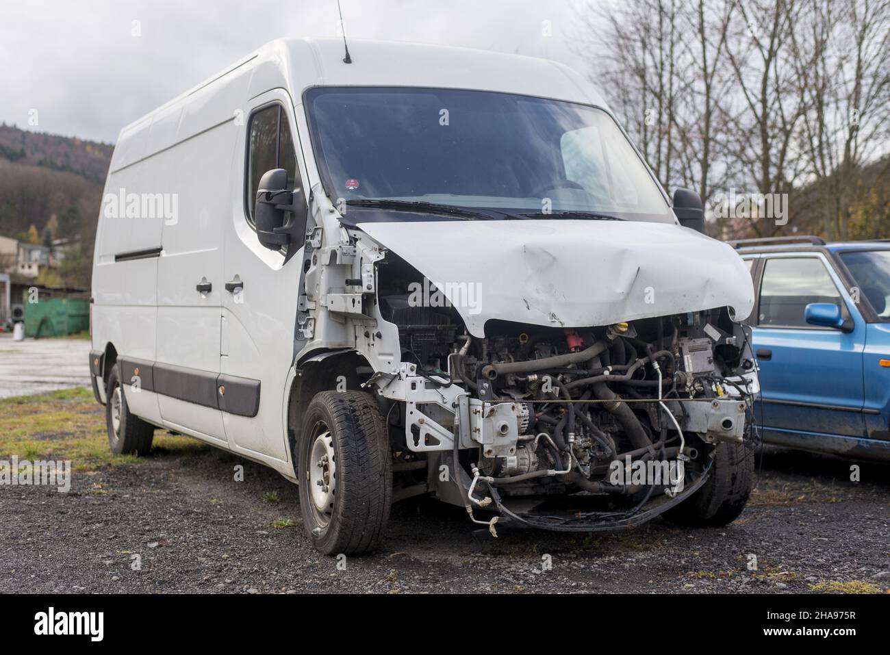 Minivan in the street on a gloomy day with the damaged frontal part ...