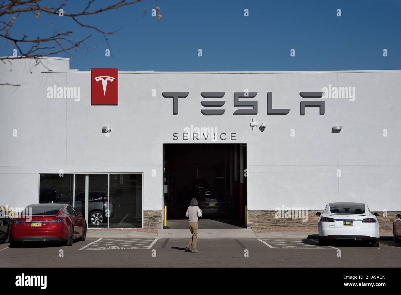 A woman approaches the service department of a Tesla automobile ...