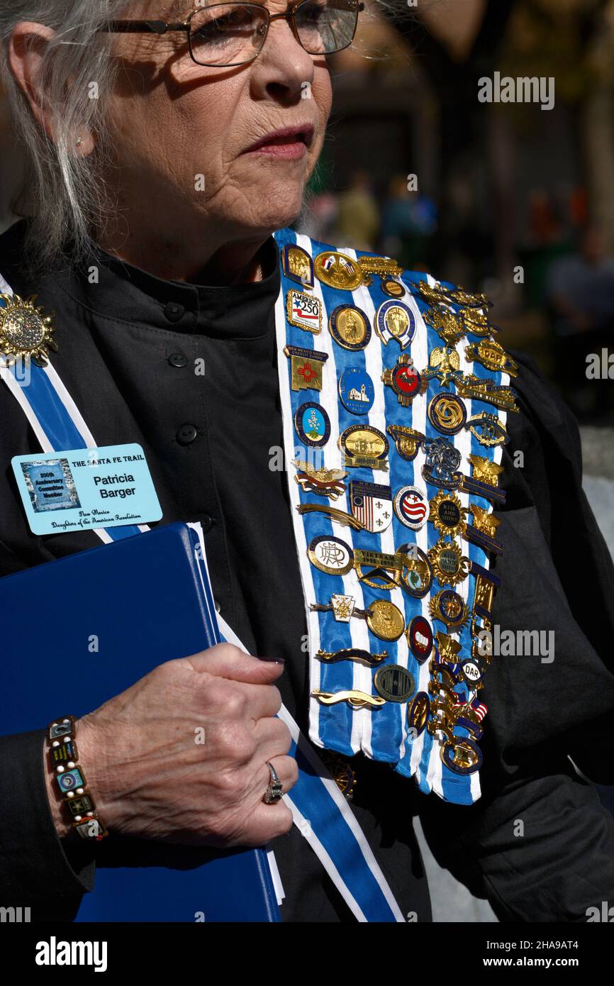 A member of the Daughters of the American Revolution wears her DAR pins ...