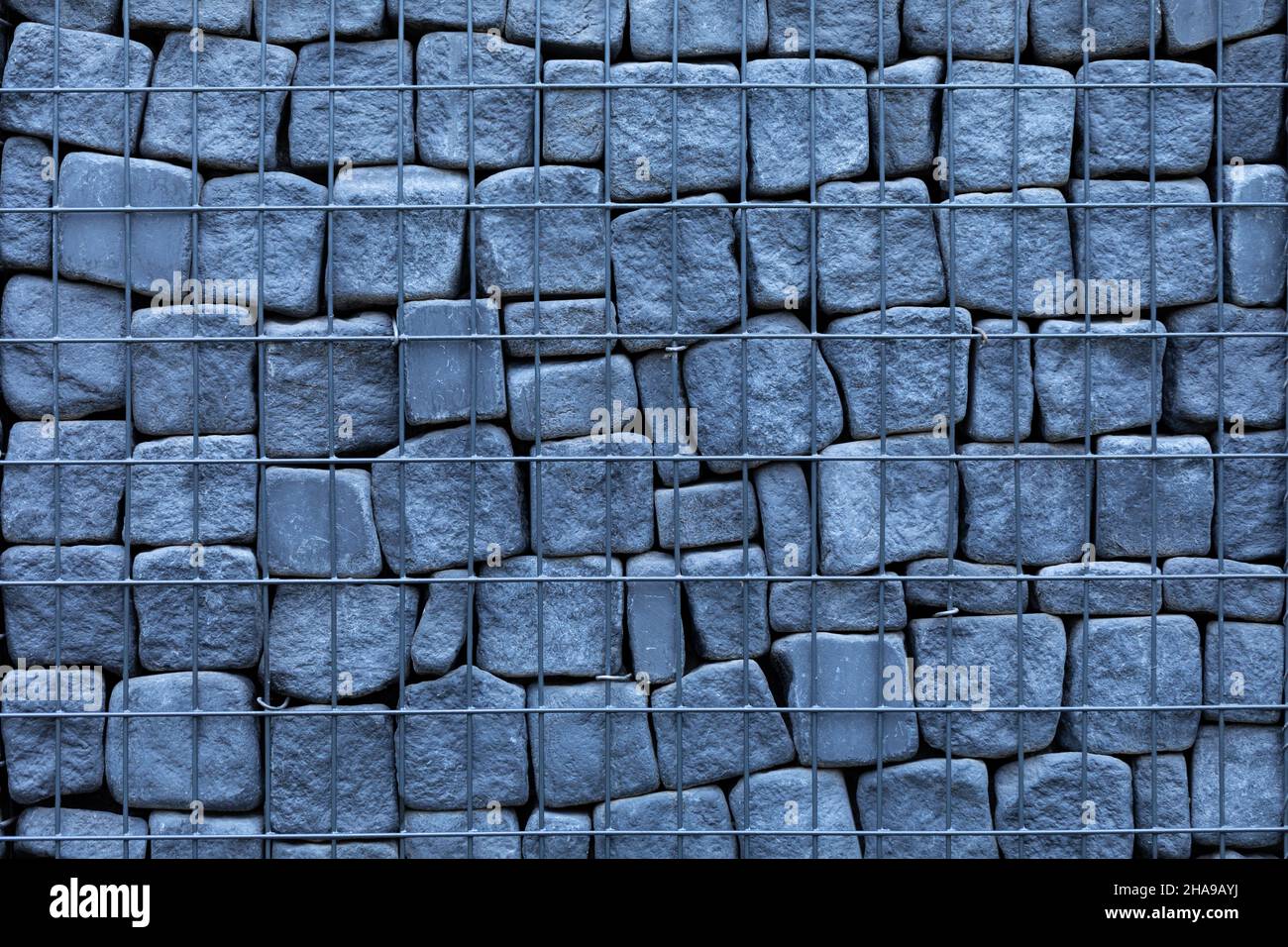 Gray-blue stone gabion of rectangular stone. Metal mesh with large ...