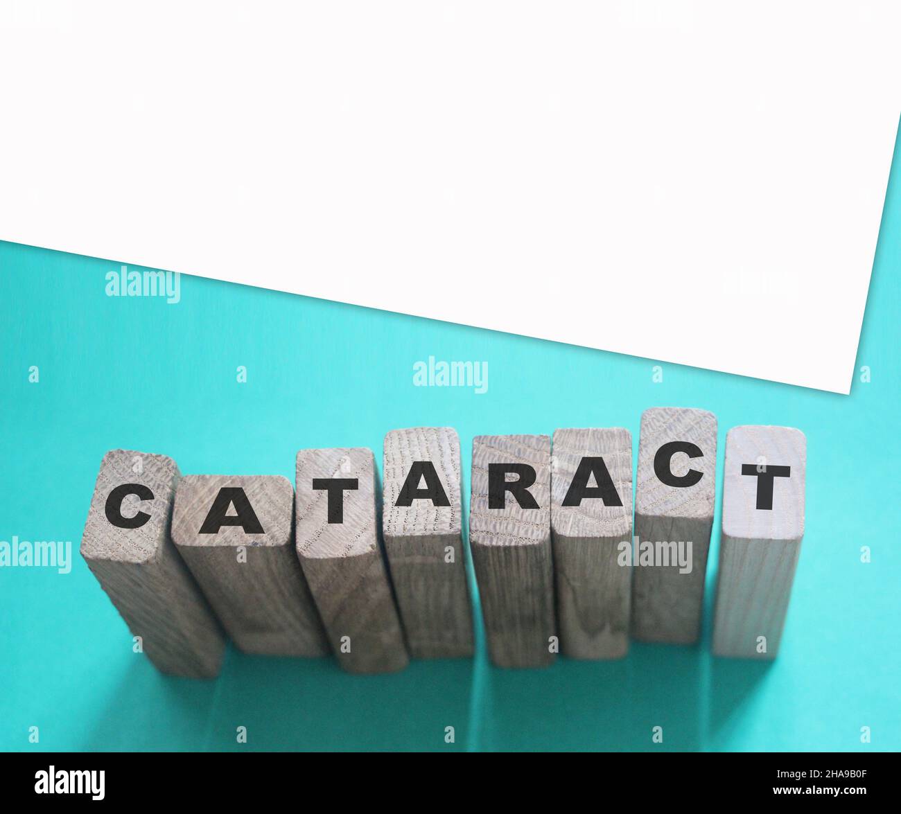 Cataract word made with building blocks on light cyan. Eye healthcare ...