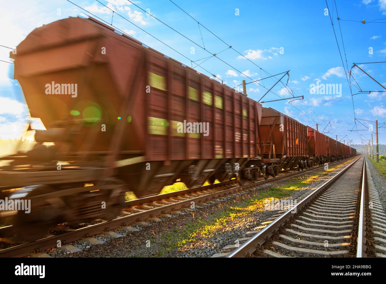 The train with freight cars moves by rail at high speeds Stock Photo ...