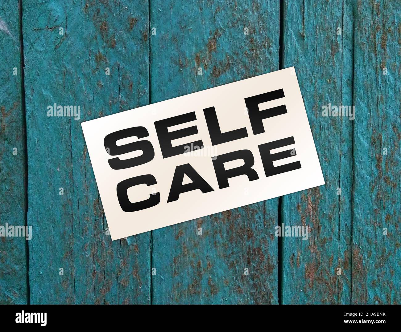 Self care text on card on wooden background. Healthcare concept. Stay ...