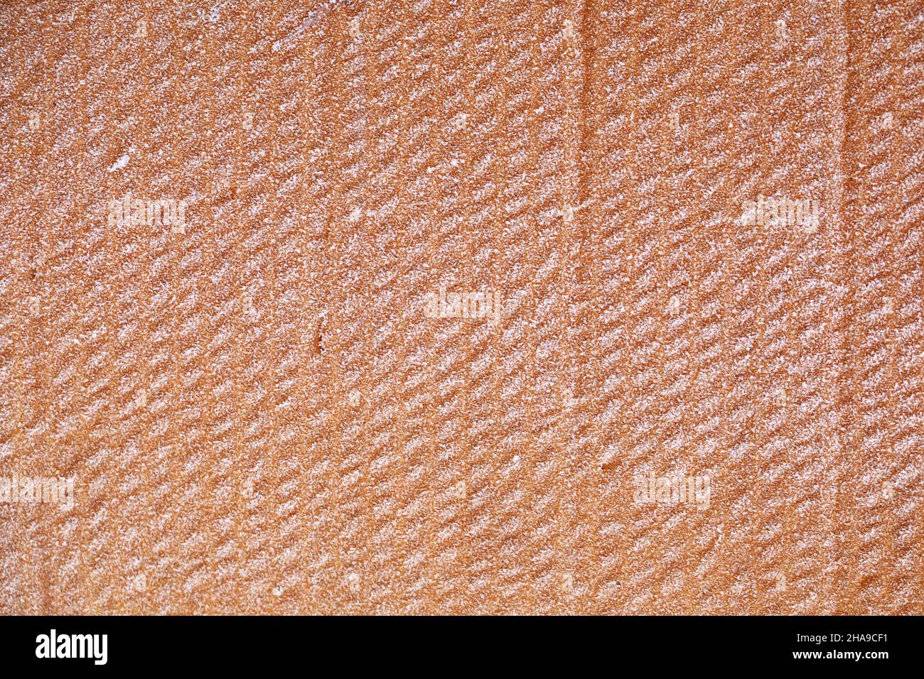 High-quality texture of yellow wet cardboard is covered with frost ...