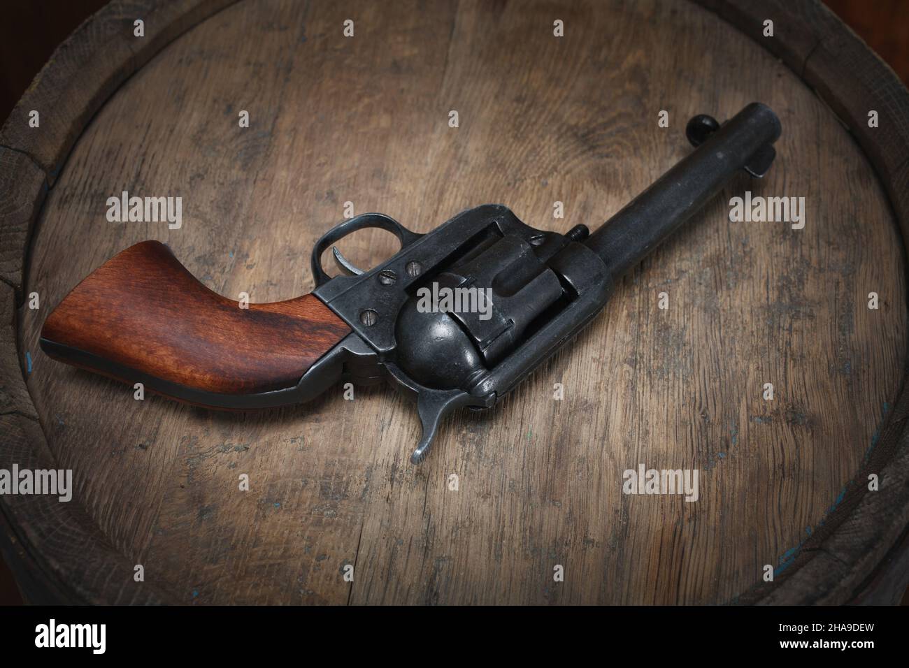 Old west revolver 45 cal on vintge wooden barrel Stock Photo - Alamy