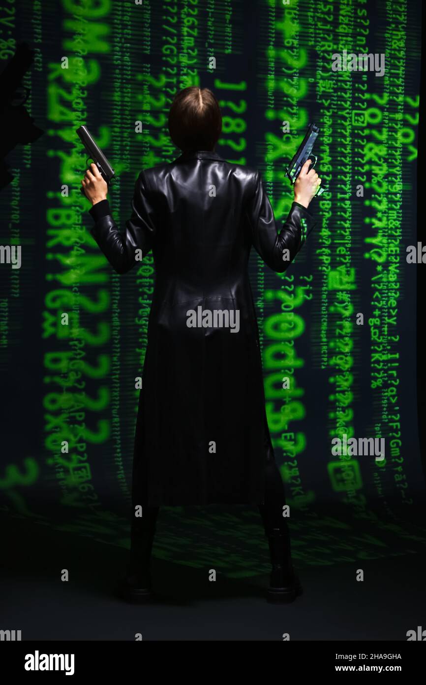 Woman with guns dressed in matrix style on dark background Stock Photo ...