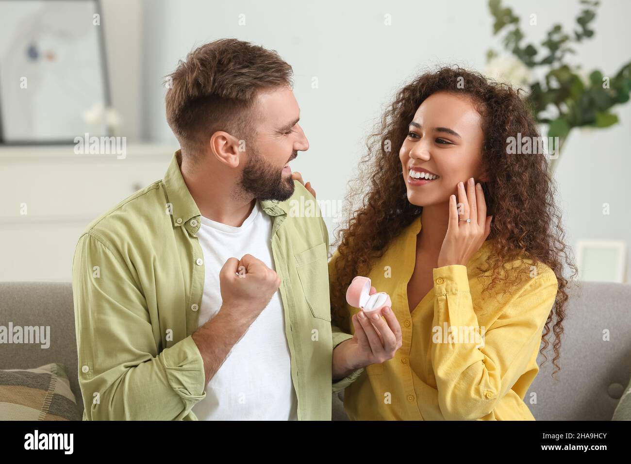 Happy young engaged couple at home Stock Photo - Alamy