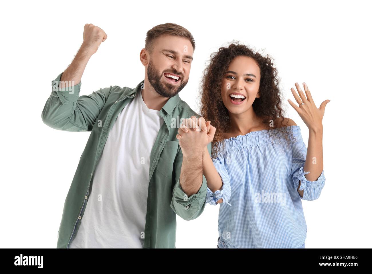 Happy young engaged couple on white background Stock Photo - Alamy