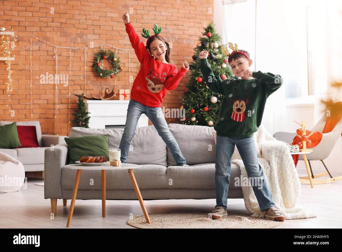 Happy little children dancing at home on Christmas eve Stock Photo - Alamy