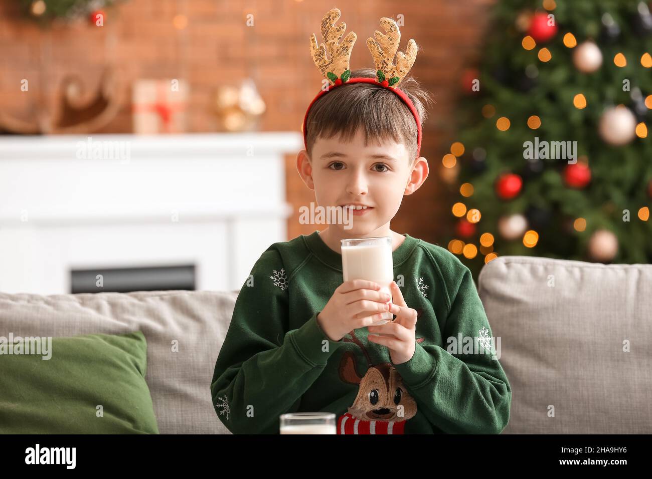 Portrait of little boy drinking milk at home on Christmas eve Stock ...