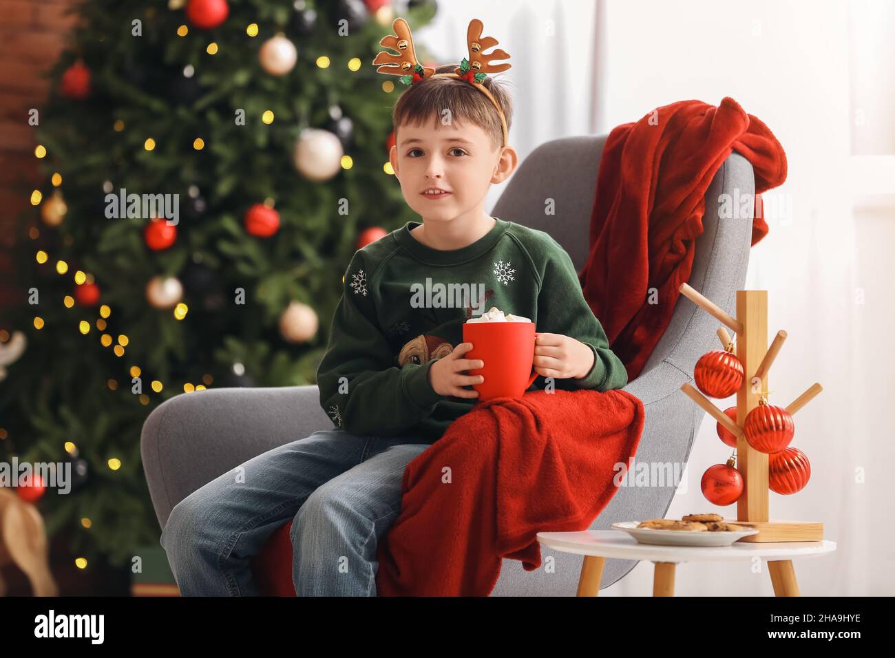 Funny little boy drinking hot chocolate at home on Christmas eve Stock ...