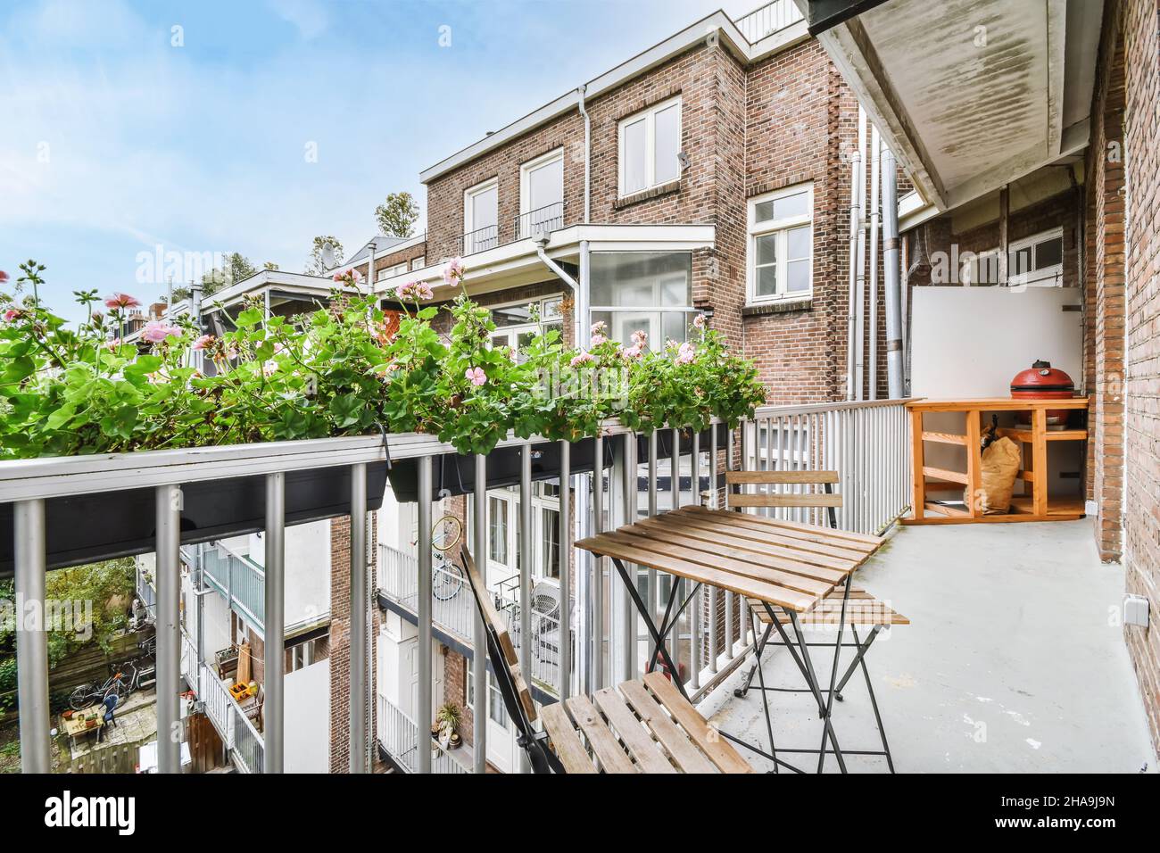 Elegant narrow and long balcony with wooden table and chairs Stock ...