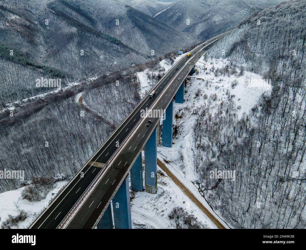 Amazing aerial view of a road. Stunning snow landscape with river and ...