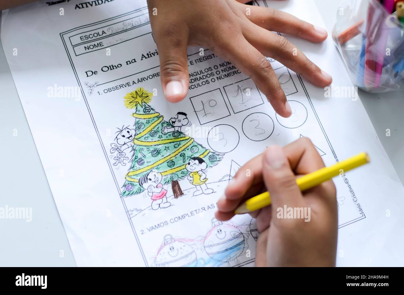 Hands with colored pencils drawing on paper. Salvador, Bahia, Brazil ...