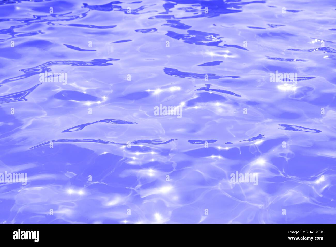 Rippled water surface with many drops. Caustics on the surface of the ...