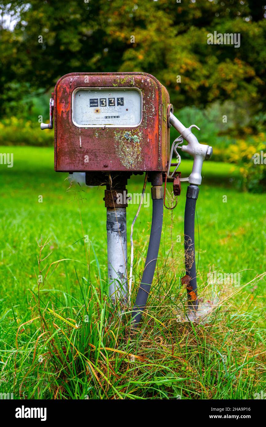 A vertical shot of a vintage rusty gas pamp in a park Stock Photo - Alamy