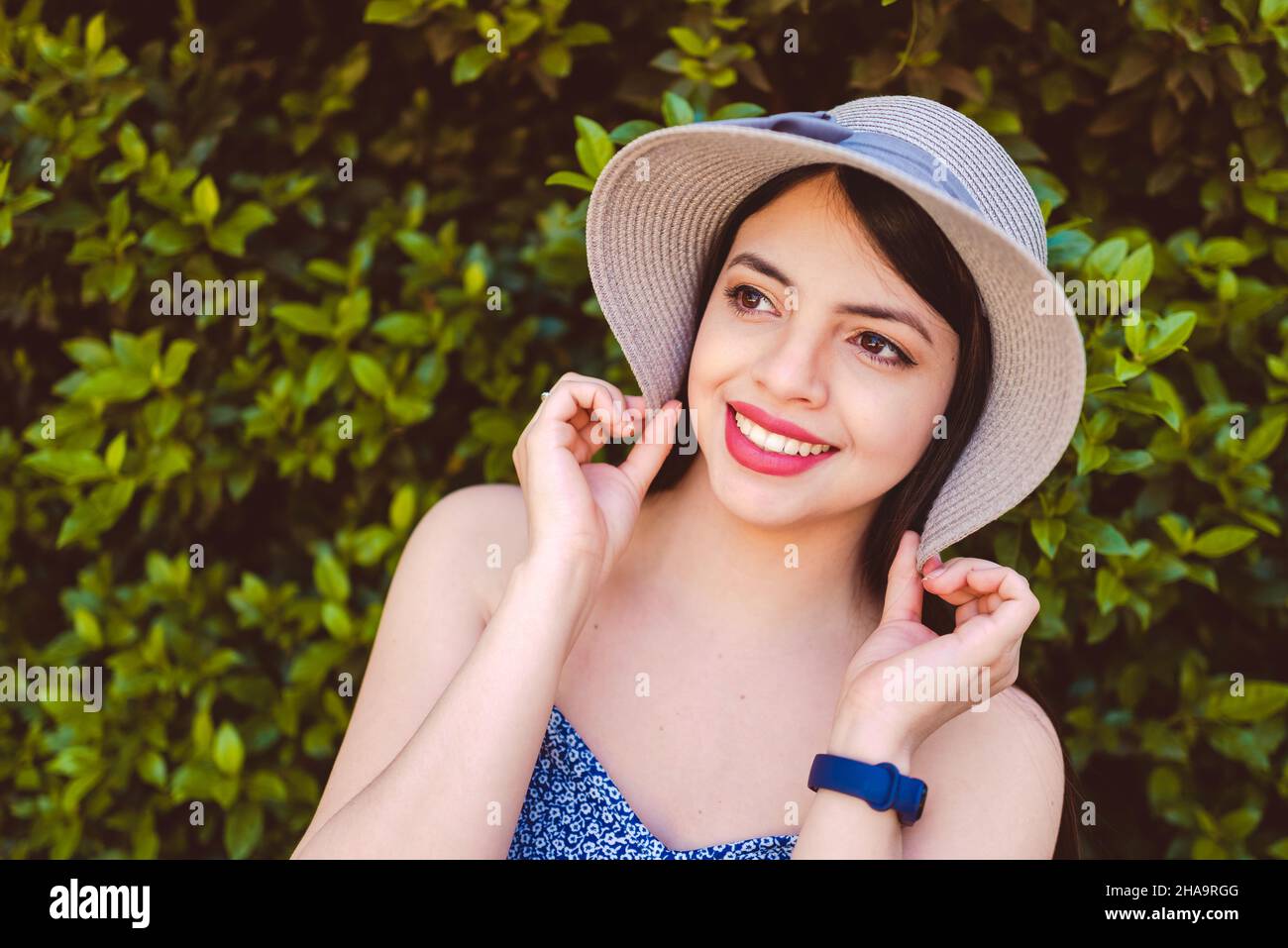 Young woman portrait using a hat at park at spring summer season Stock ...