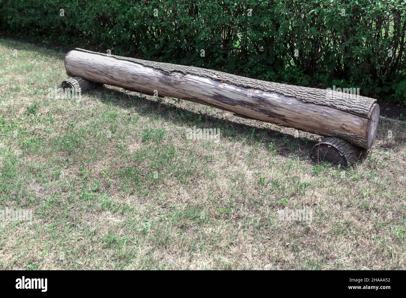 Rustic bench made by large log . Wooden Seat on the grass Stock Photo ...