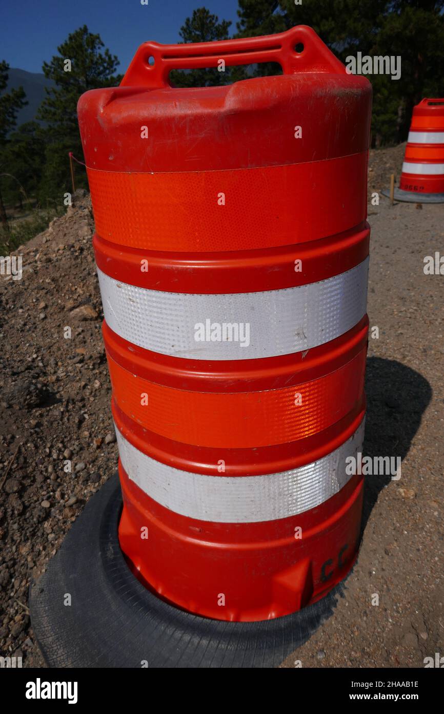 Bright orange traffic barrel with reflective stripes Stock Photo - Alamy