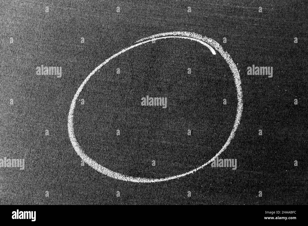 White chalk hand drawing as circle shape on blackboard or chalkboard ...