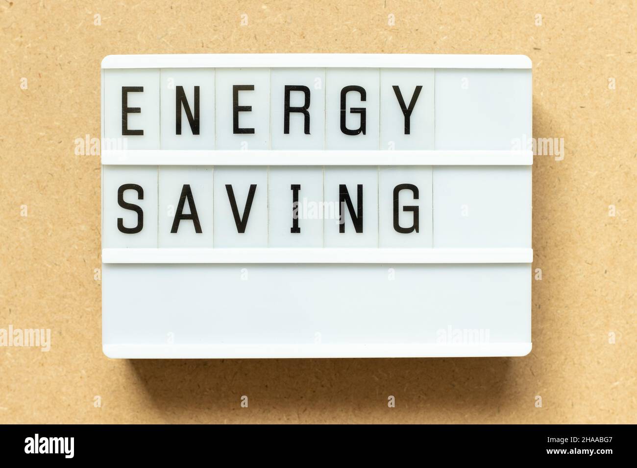 Lightbox with word energy saving on wood background Stock Photo - Alamy
