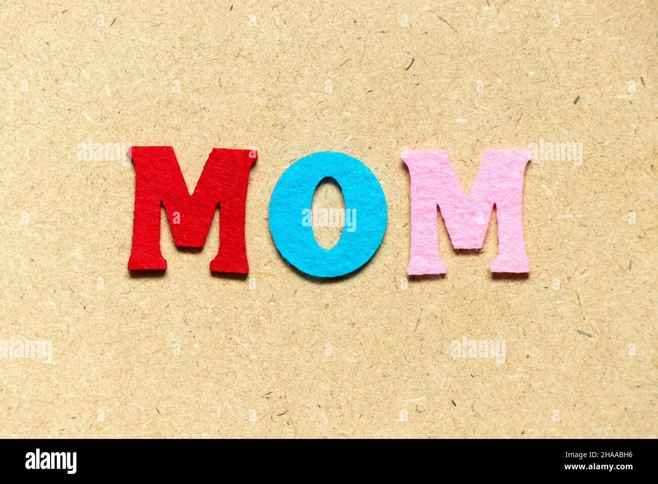 Color cloth alphabet letter in word mom on wood background Stock Photo ...