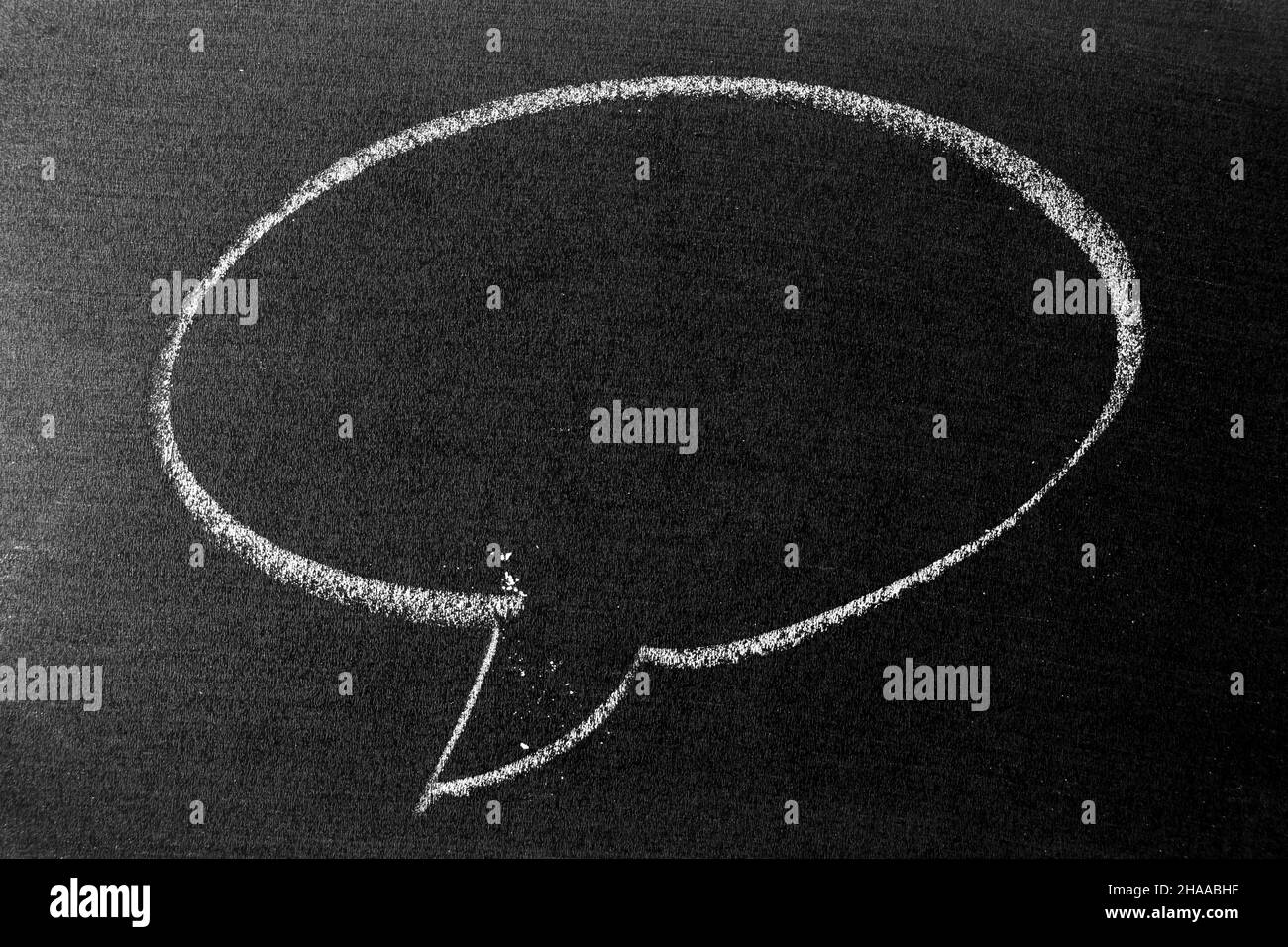 White color chalk hand drawing in round bubble speech shape with blank ...