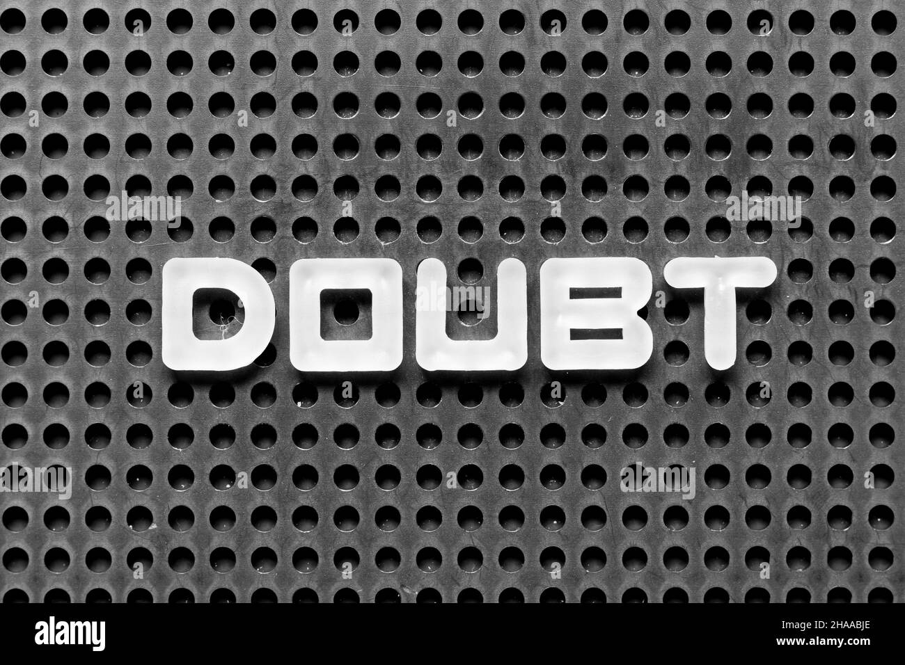 White alphabet letter in word doubt on black pegboard background Stock ...