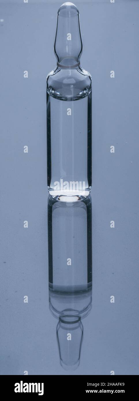 Glass medical ampoule vial for injection. Medicine is dry white drug ...